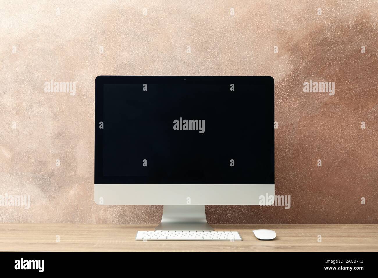 Workplace. Computer, keyboard and mouse on wooden table. Light brown ...