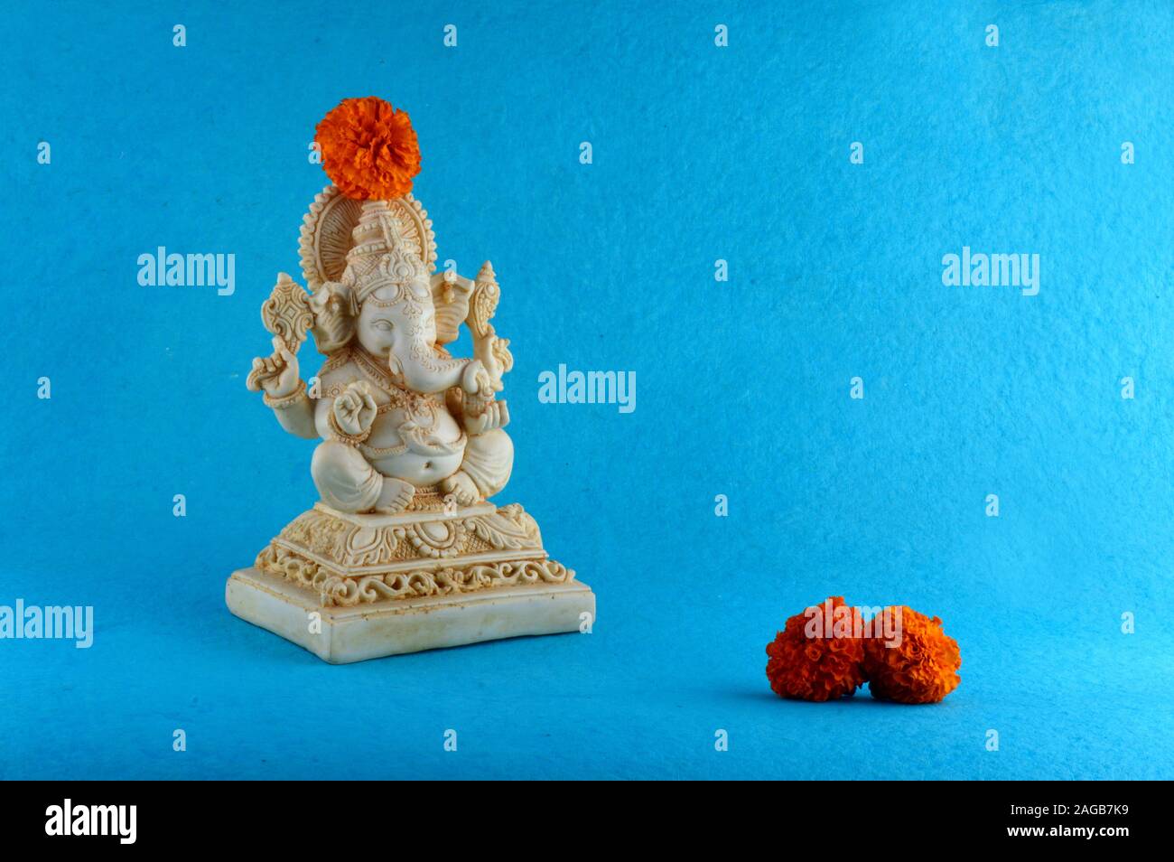 Hindu God Ganesha. Ganesha Idol on blue background Stock Photo - Alamy