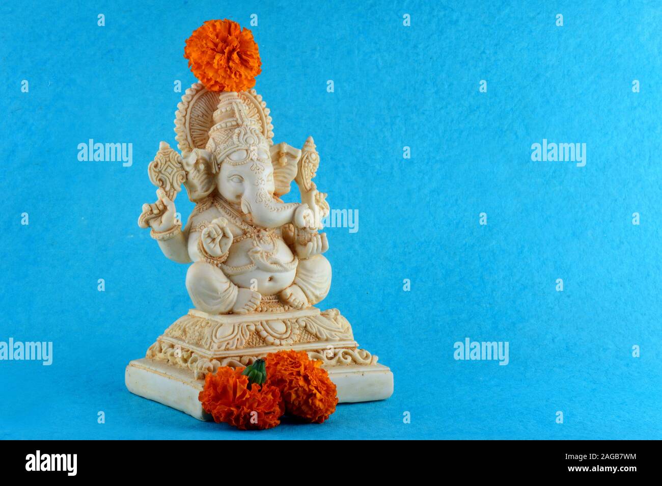 Hindu God Ganesha. Ganesha Idol on blue background Stock Photo - Alamy