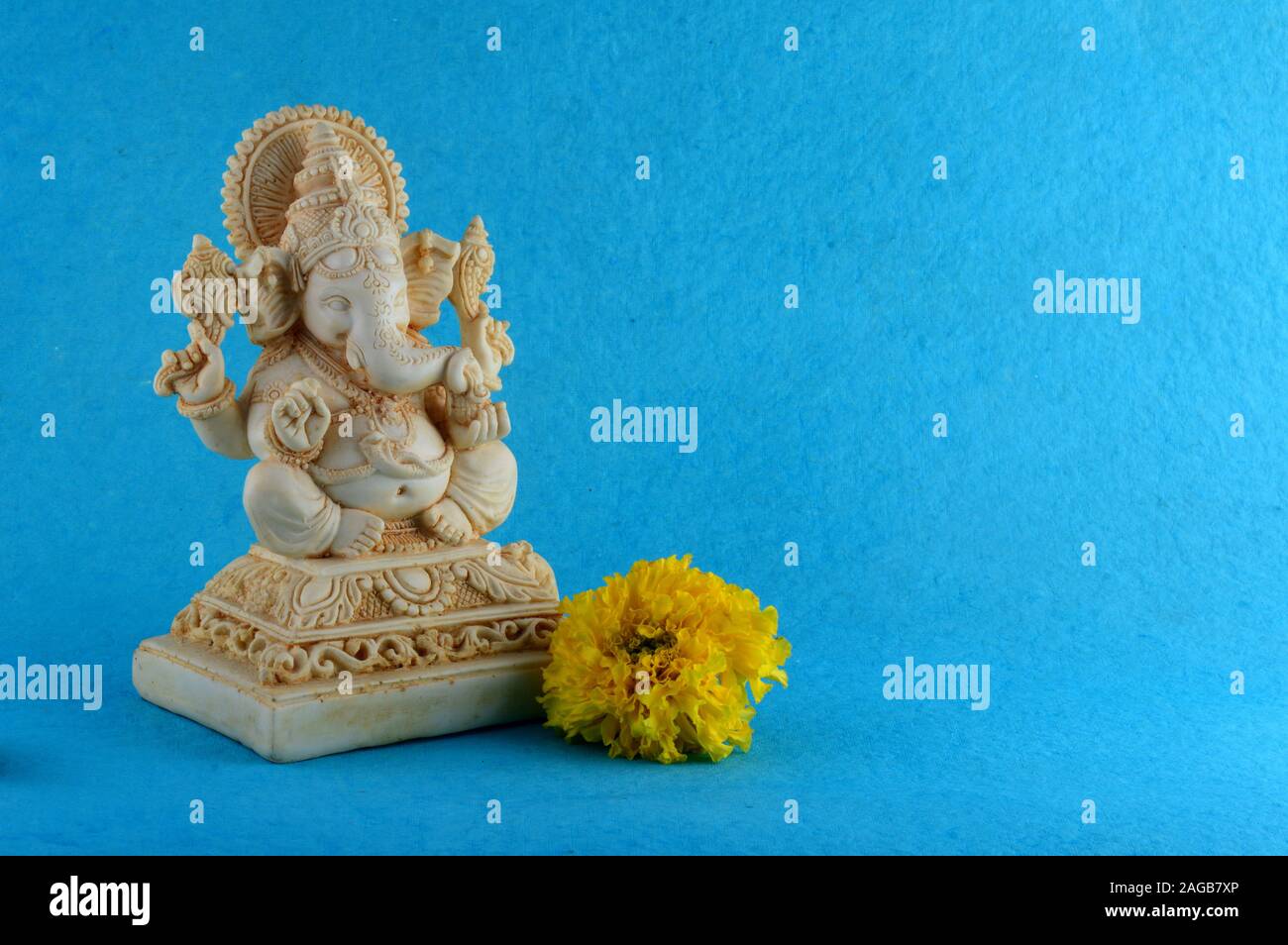 Hindu God Ganesha. Ganesha Idol on blue background Stock Photo - Alamy