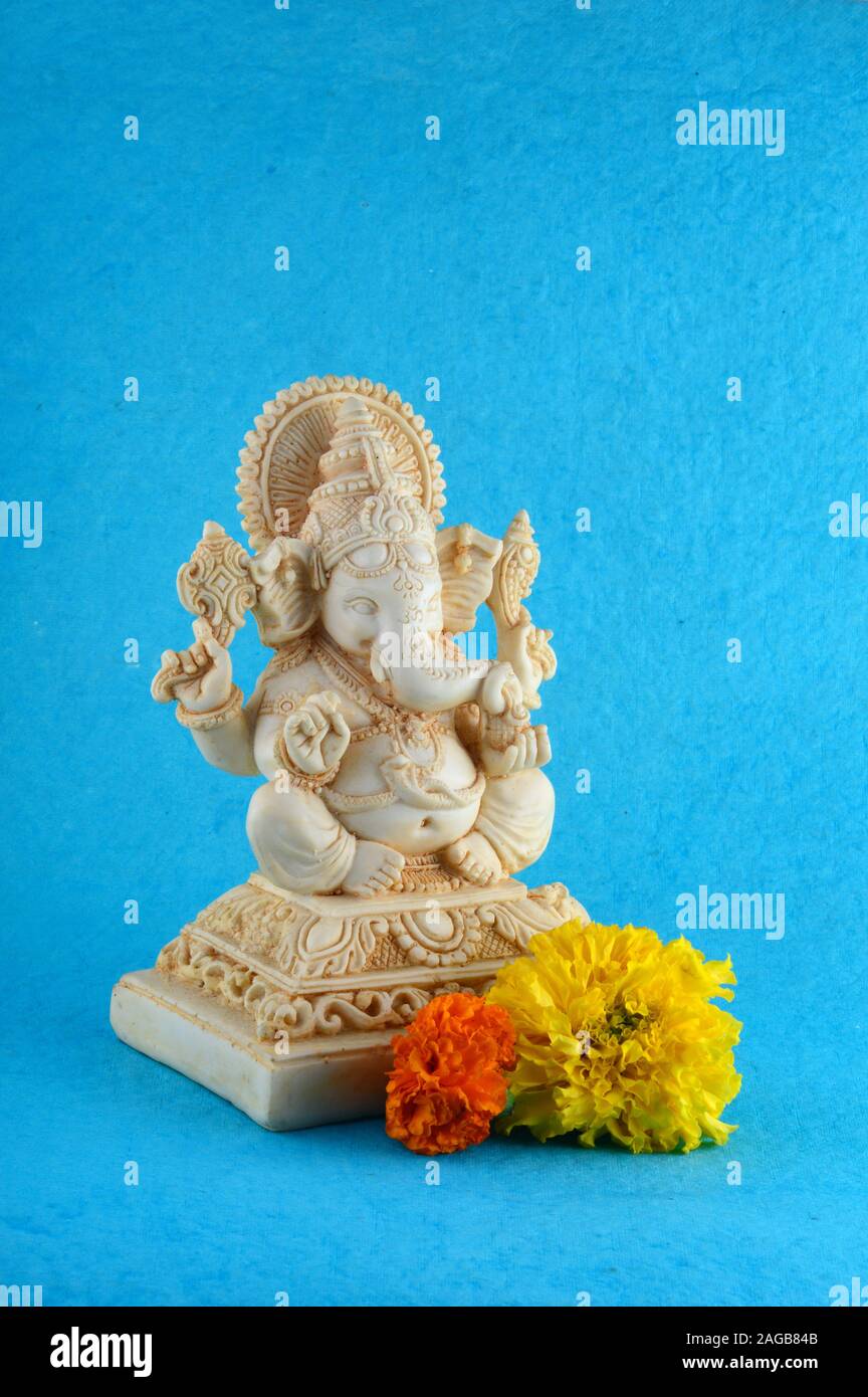 Hindu God Ganesha. Ganesha Idol on blue background Stock Photo - Alamy