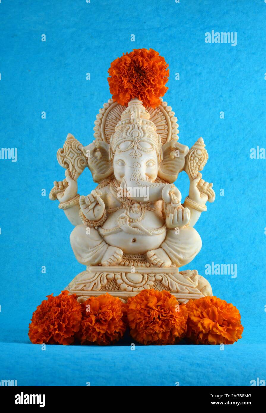 Hindu God Ganesha. Ganesha Idol on blue background Stock Photo - Alamy