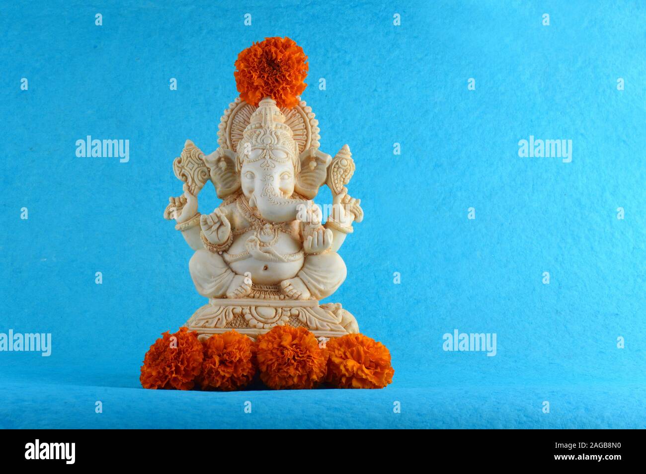 Hindu God Ganesha. Ganesha Idol on blue background Stock Photo - Alamy