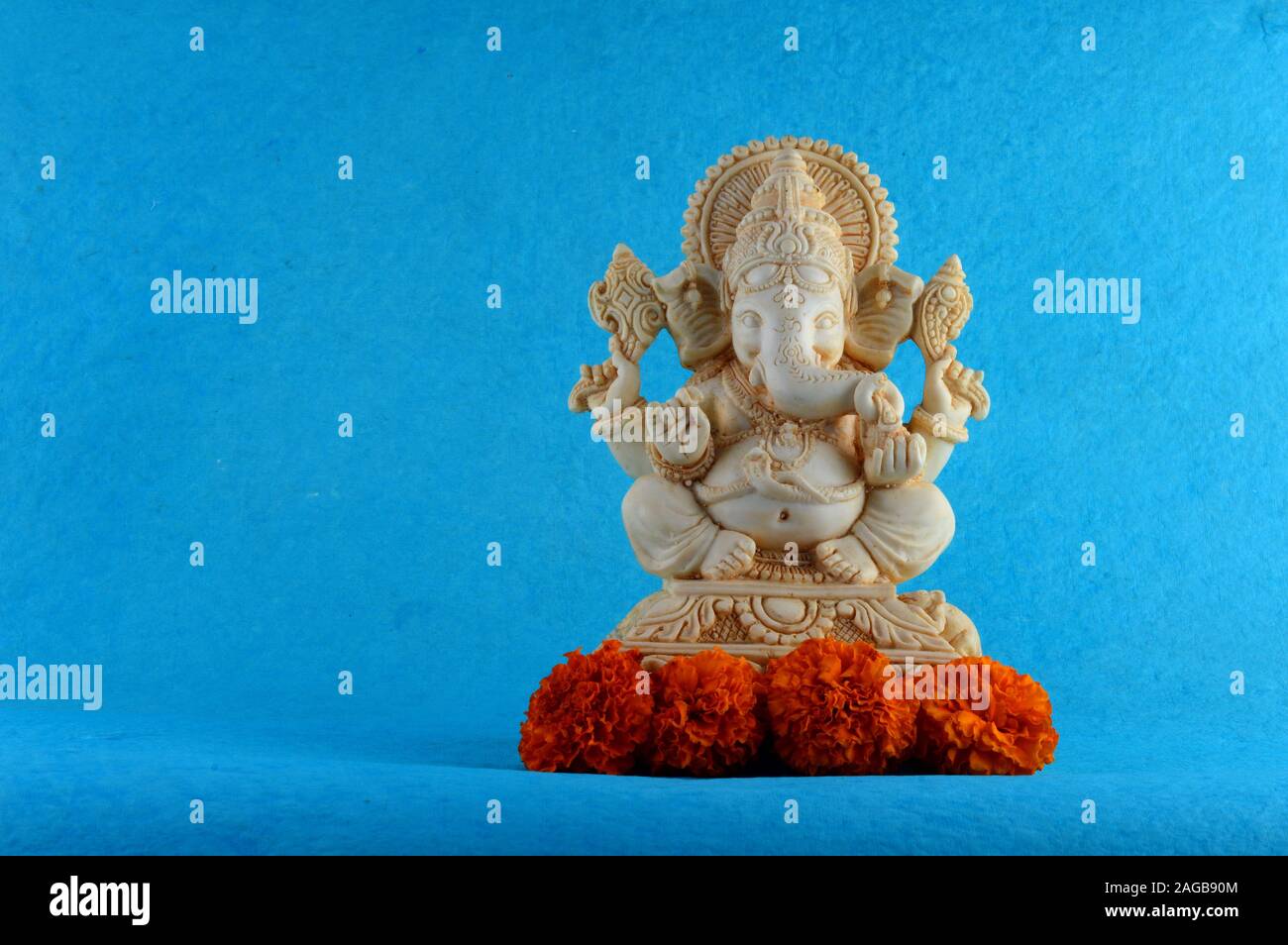 Hindu God Ganesha. Ganesha Idol on blue background Stock Photo - Alamy