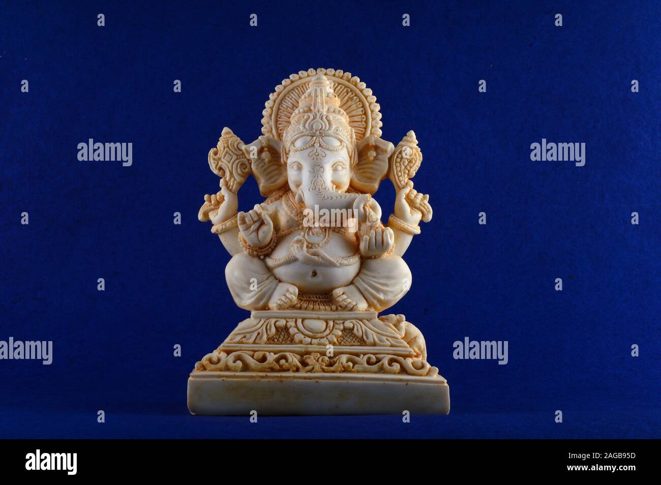 Hindu God Ganesha. Ganesha Idol on blue background Stock Photo - Alamy