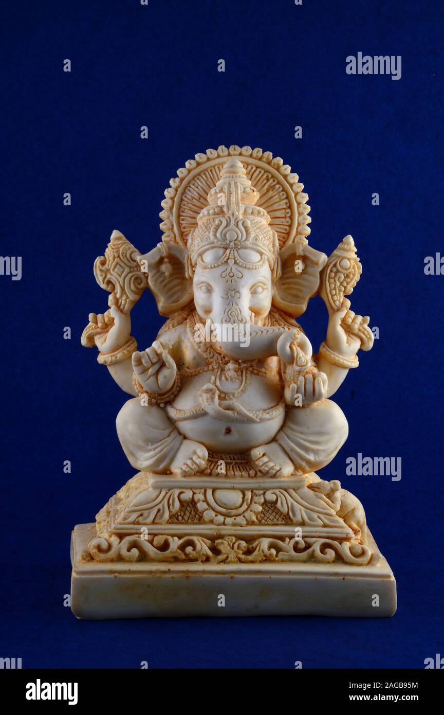 Hindu God Ganesha. Ganesha Idol on blue background Stock Photo - Alamy
