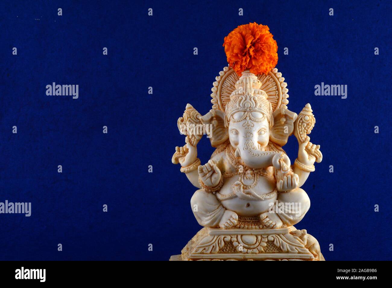 Hindu God Ganesha. Ganesha Idol on blue background Stock Photo - Alamy