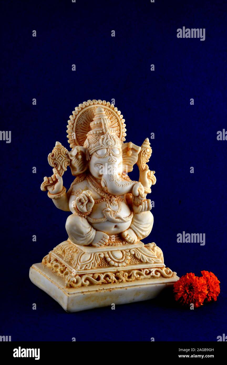 Hindu God Ganesha. Ganesha Idol on blue background Stock Photo - Alamy