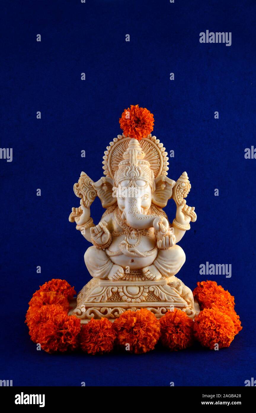 Hindu God Ganesha. Ganesha Idol on blue background Stock Photo - Alamy