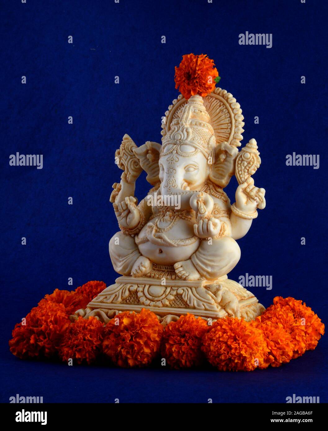 Hindu God Ganesha. Ganesha Idol on blue background Stock Photo - Alamy