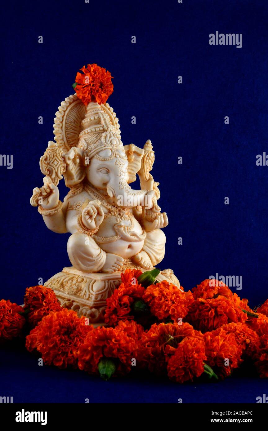 Hindu God Ganesha. Ganesha Idol on blue background Stock Photo - Alamy