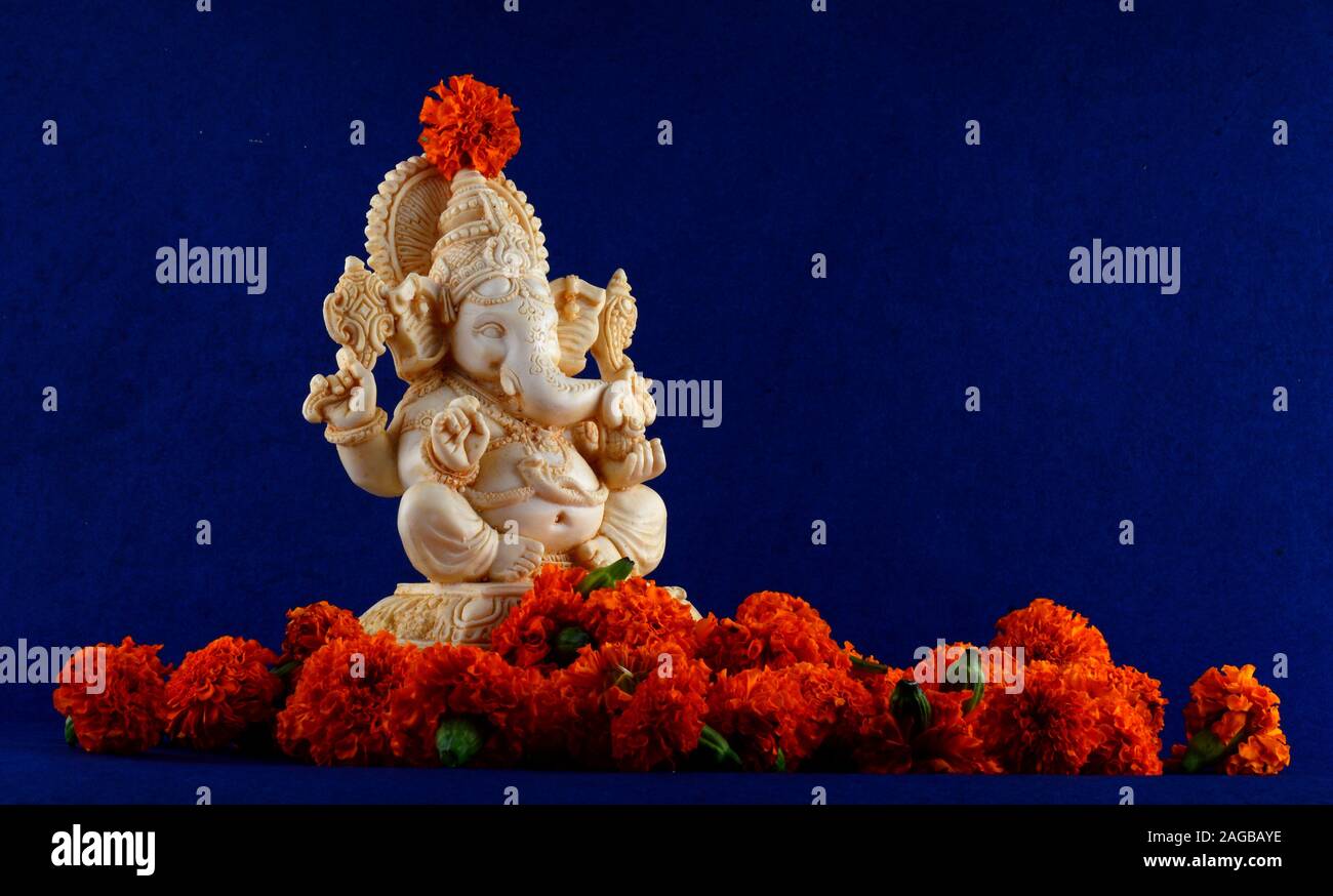 Hindu God Ganesha. Ganesha Idol on blue background Stock Photo - Alamy