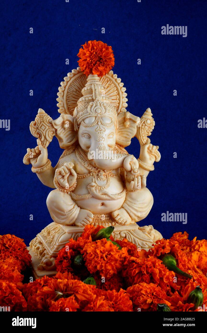 Hindu God Ganesha. Ganesha Idol on blue background Stock Photo - Alamy