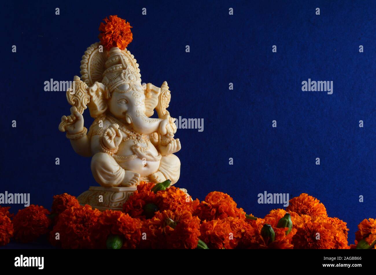 Hindu God Ganesha. Ganesha Idol on blue background Stock Photo - Alamy