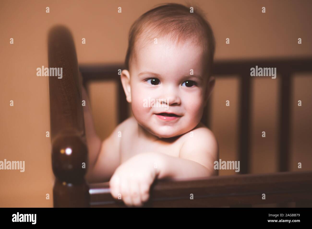 little boy chewing on her bed at home Stock Photo - Alamy