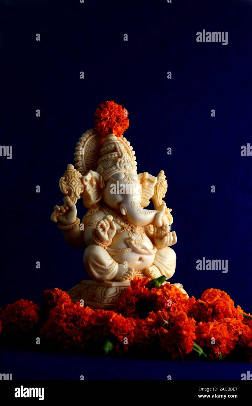 Hindu God Ganesha. Ganesha Idol on blue background Stock Photo - Alamy
