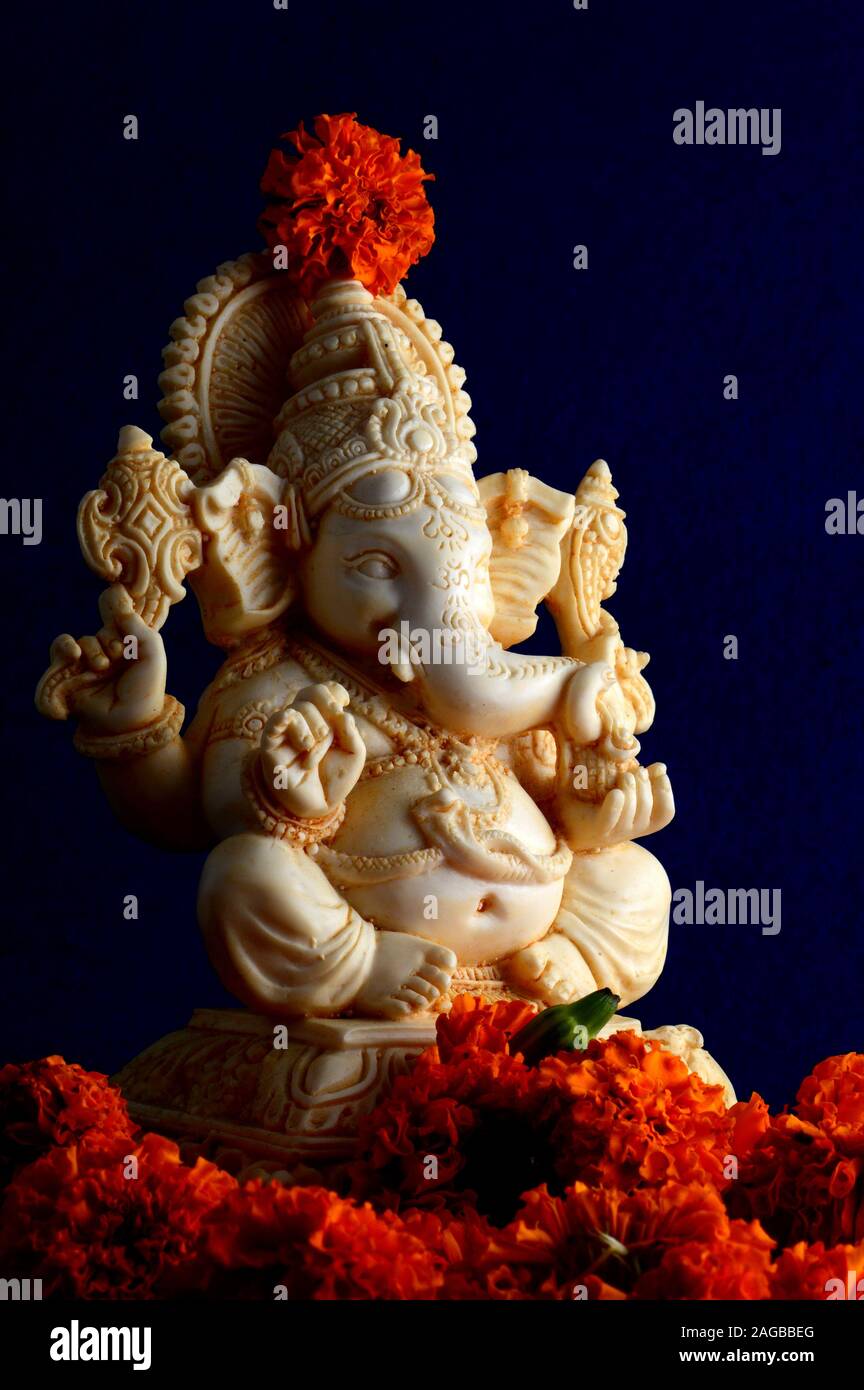 Hindu God Ganesha. Ganesha Idol on blue background Stock Photo - Alamy