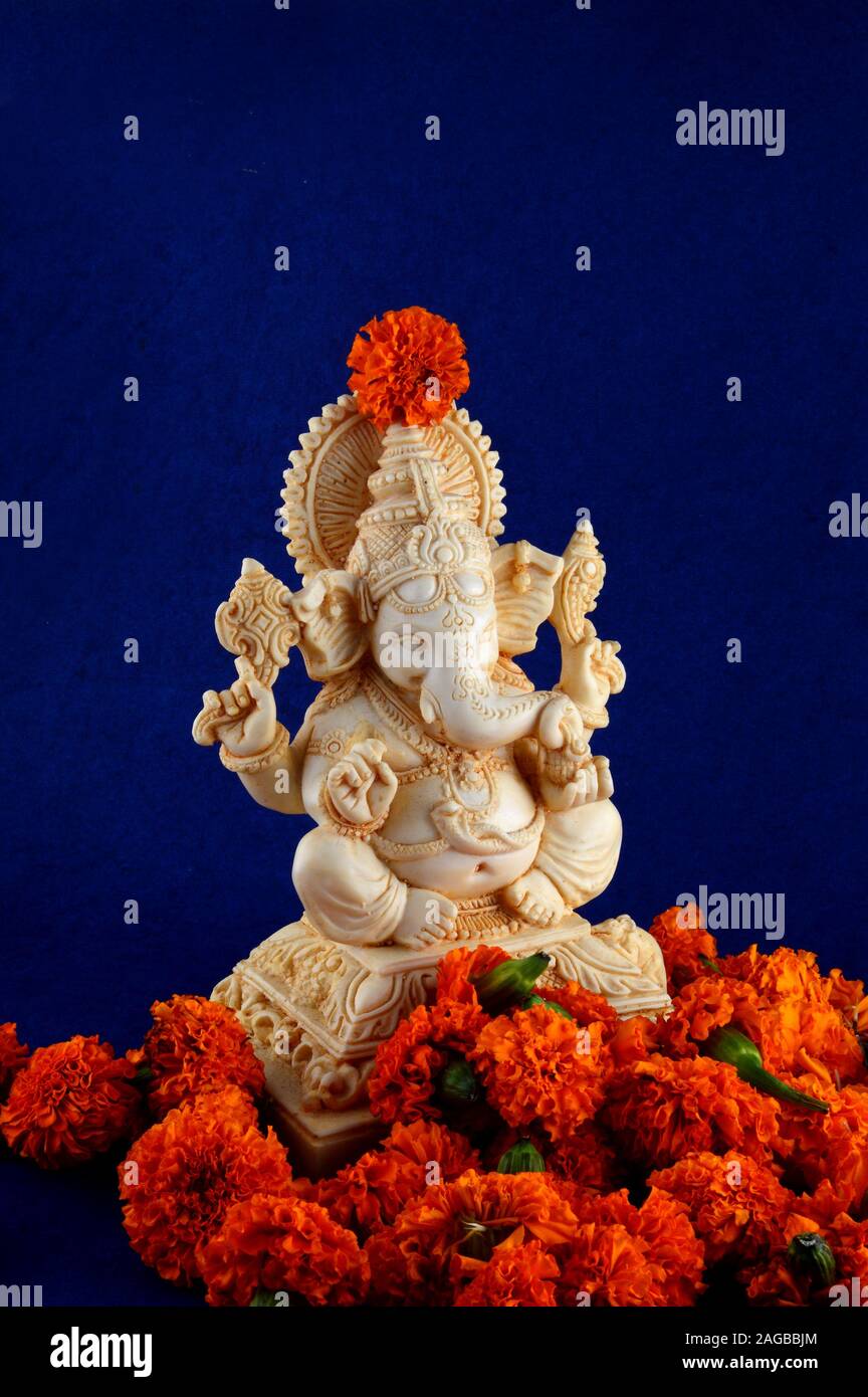 Hindu God Ganesha. Ganesha Idol on blue background Stock Photo - Alamy