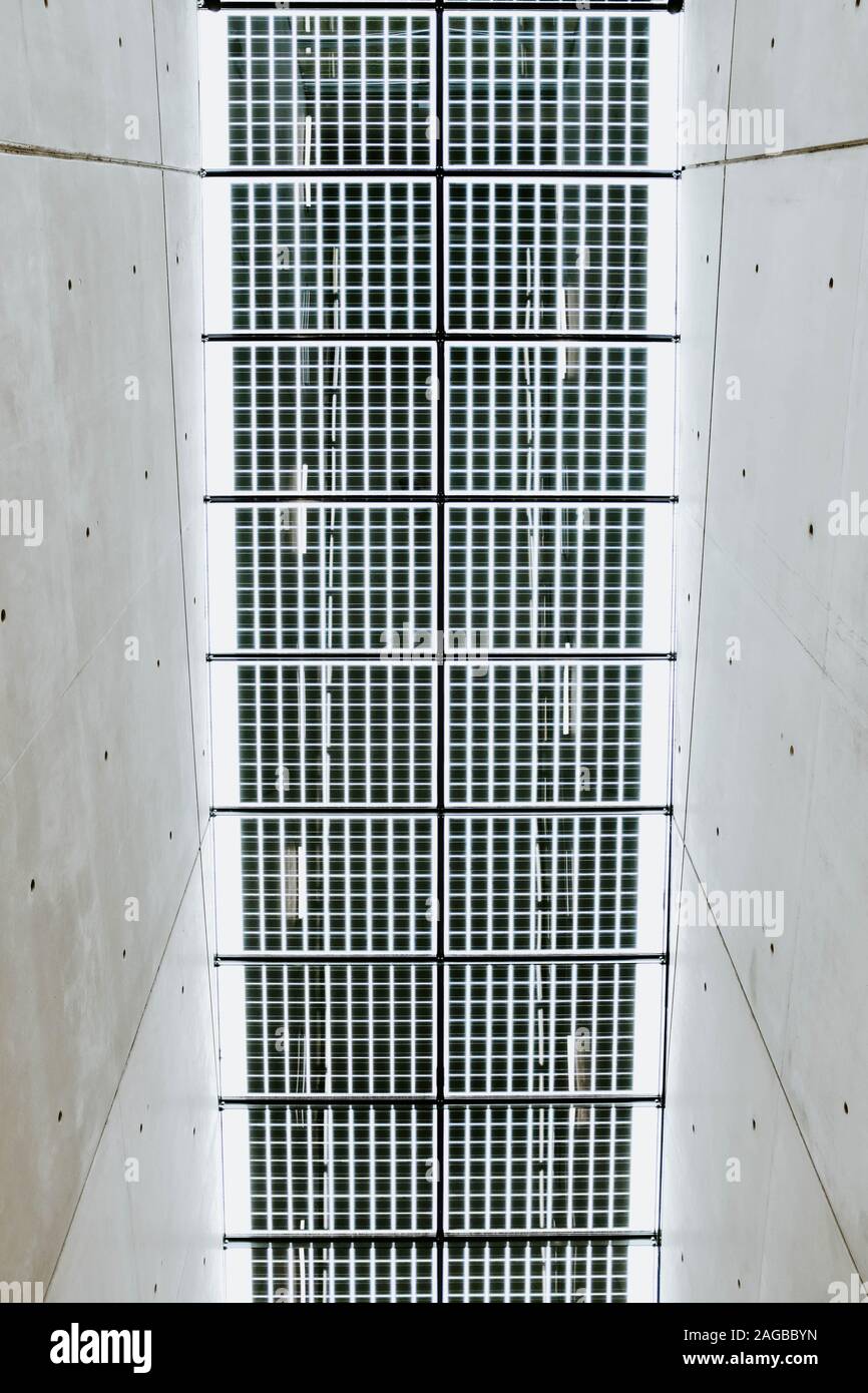 Vertical low angle shot of the metal ceiling in a white concrete ...