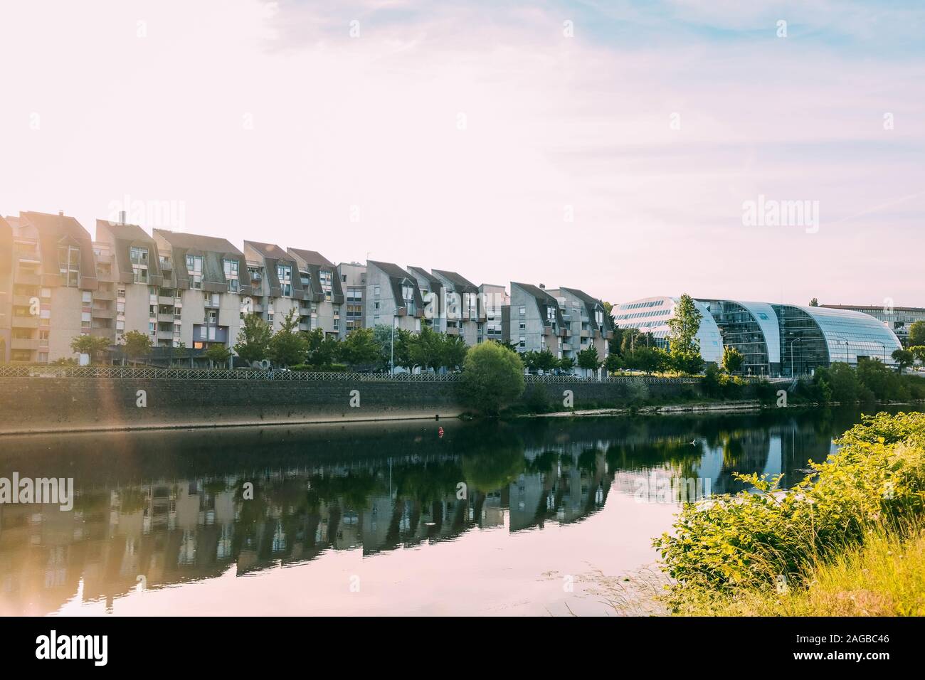 Reflection of the modern buildings in the water of a canal Stock Photo ...