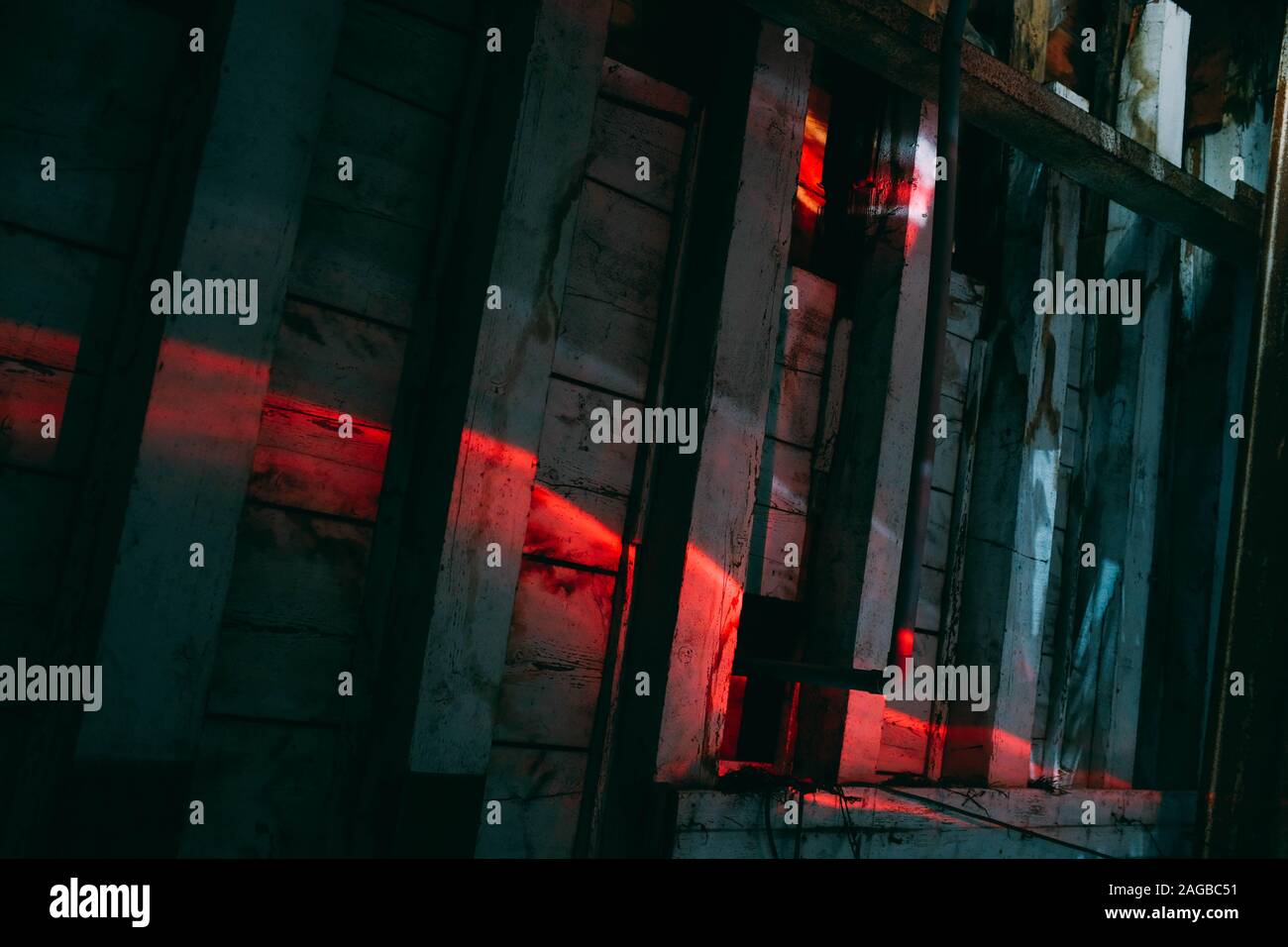 Red light shining on an old brown wooden wall Stock Photo - Alamy