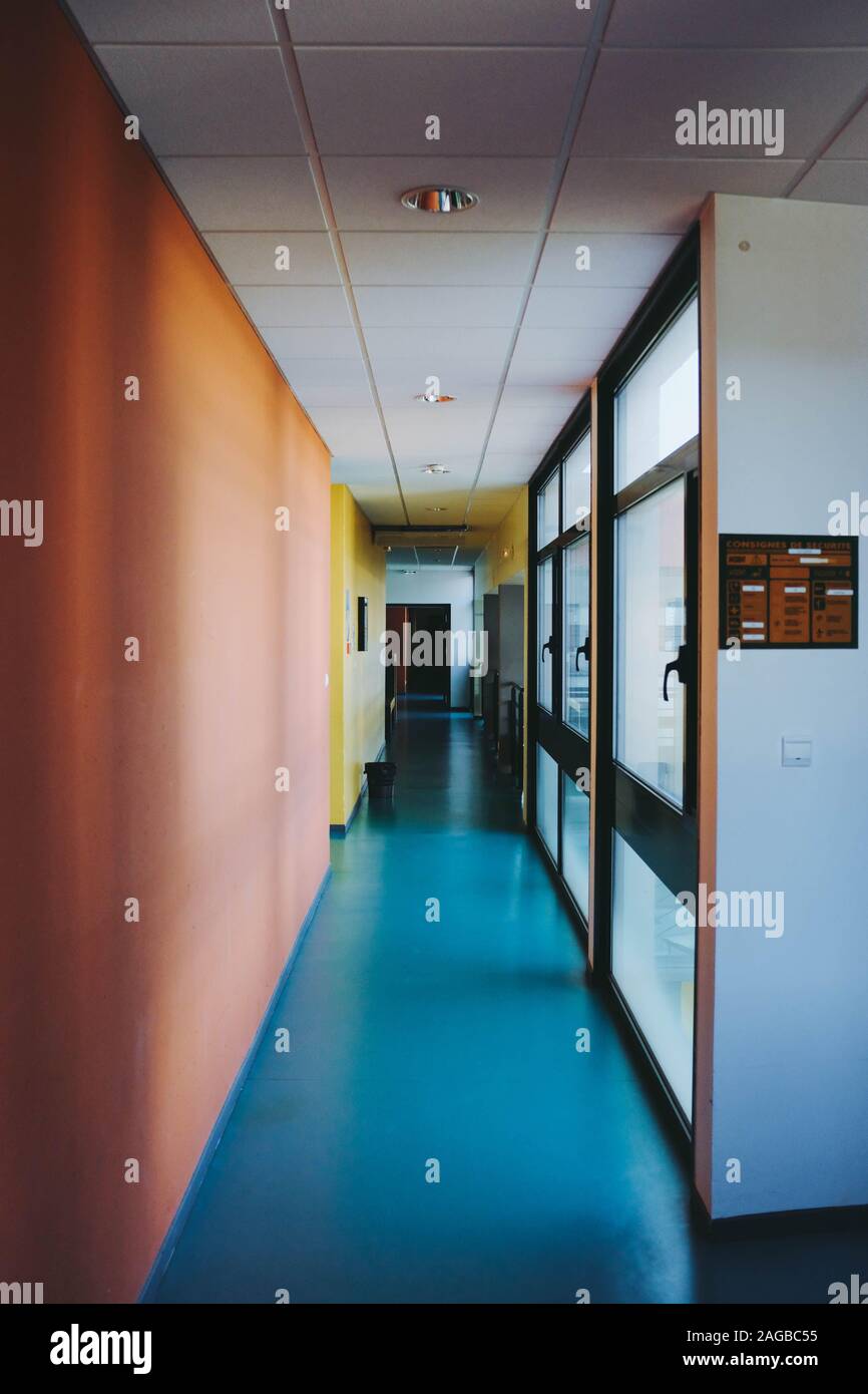 Vertical shot of a blue hallway with colorful walls and windows Stock ...