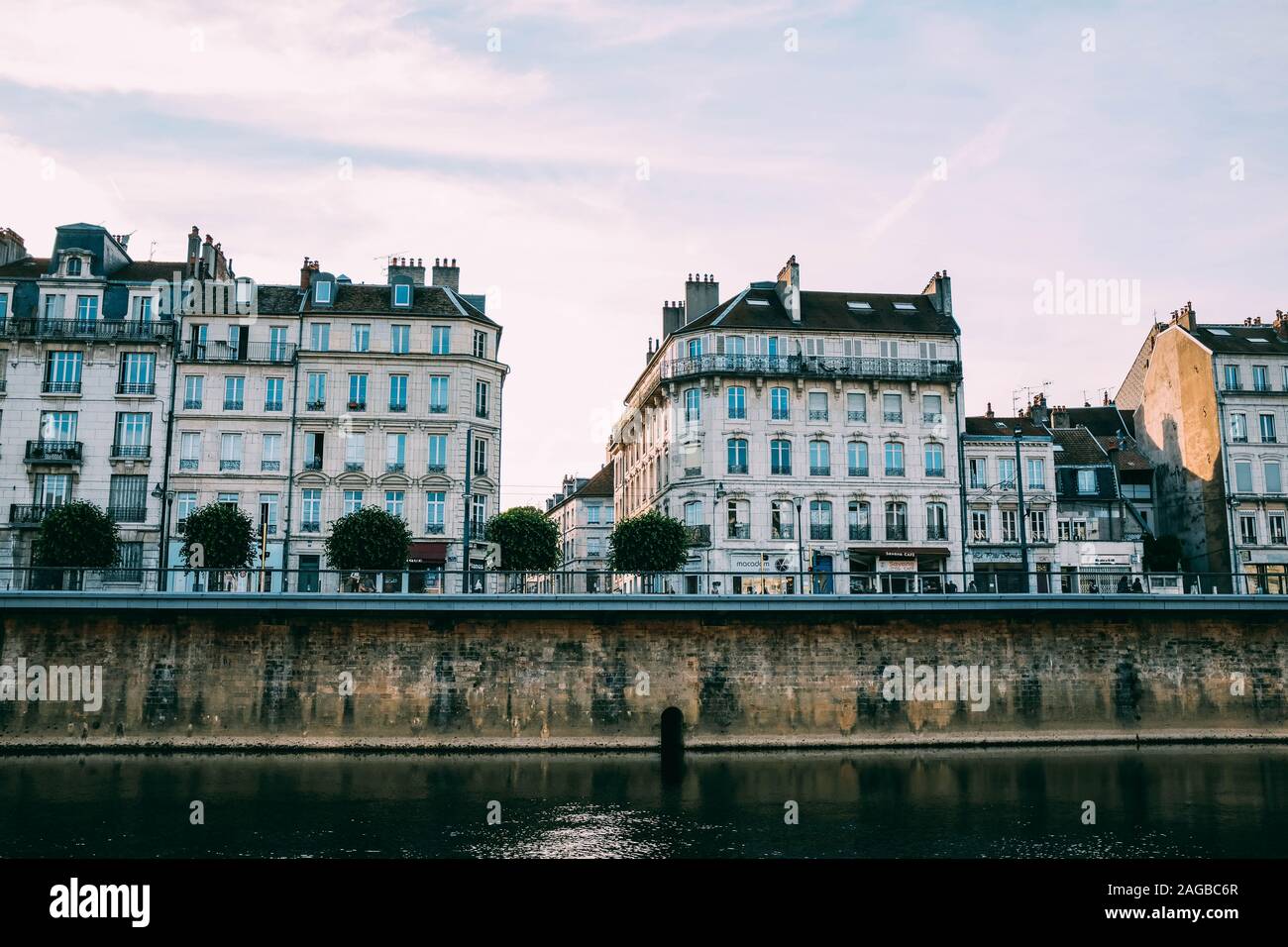 Beautiful old white concrete buildings by a canal Stock Photo - Alamy