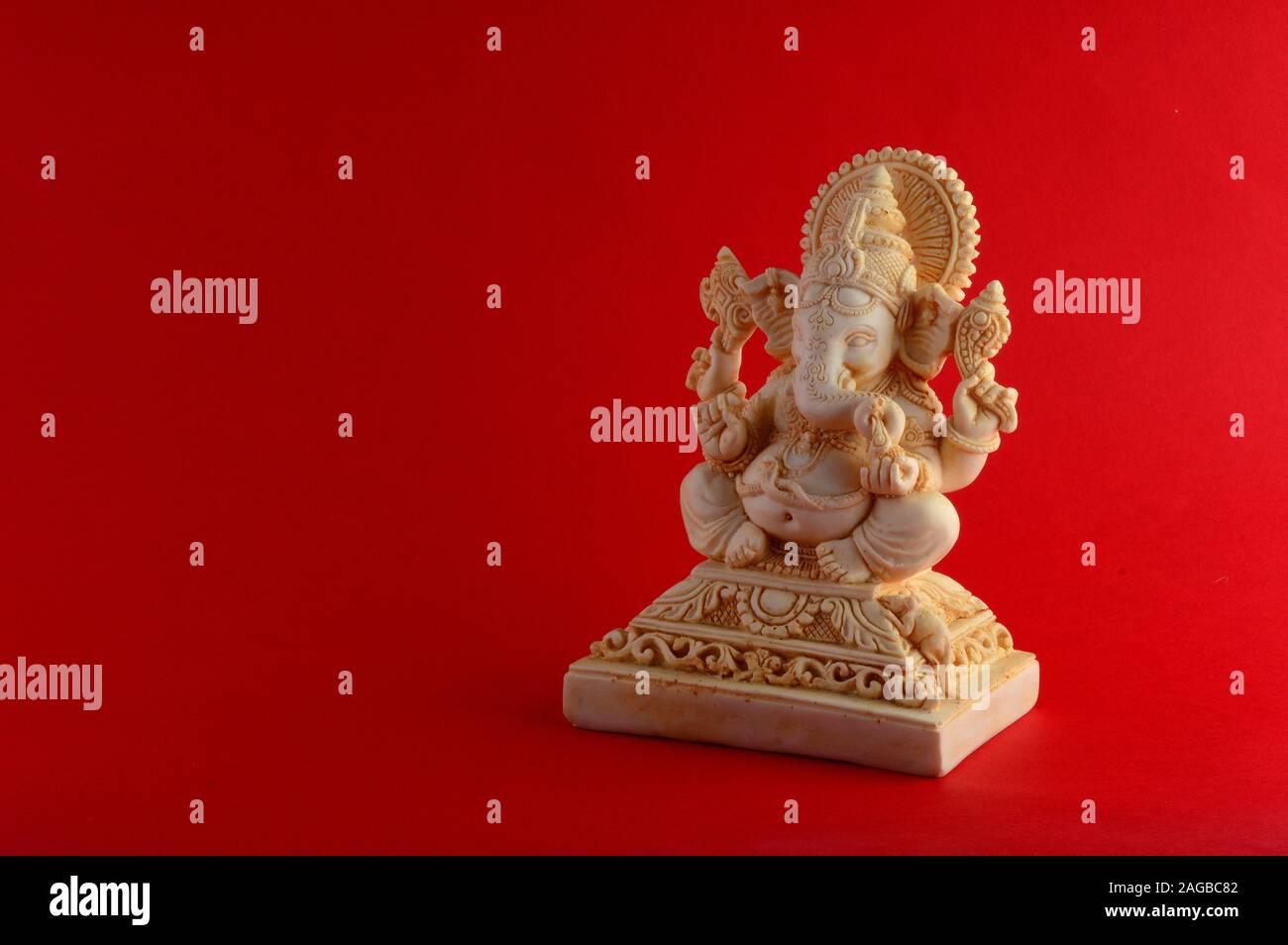Hindu God Ganesha. Ganesha Idol on red background Stock Photo - Alamy