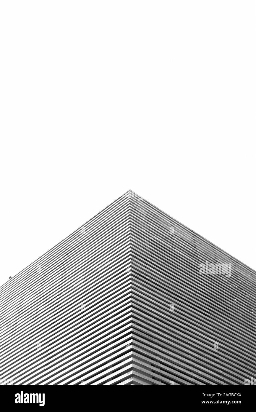 Vertical low angle greyscale shot of a concrete building with ...