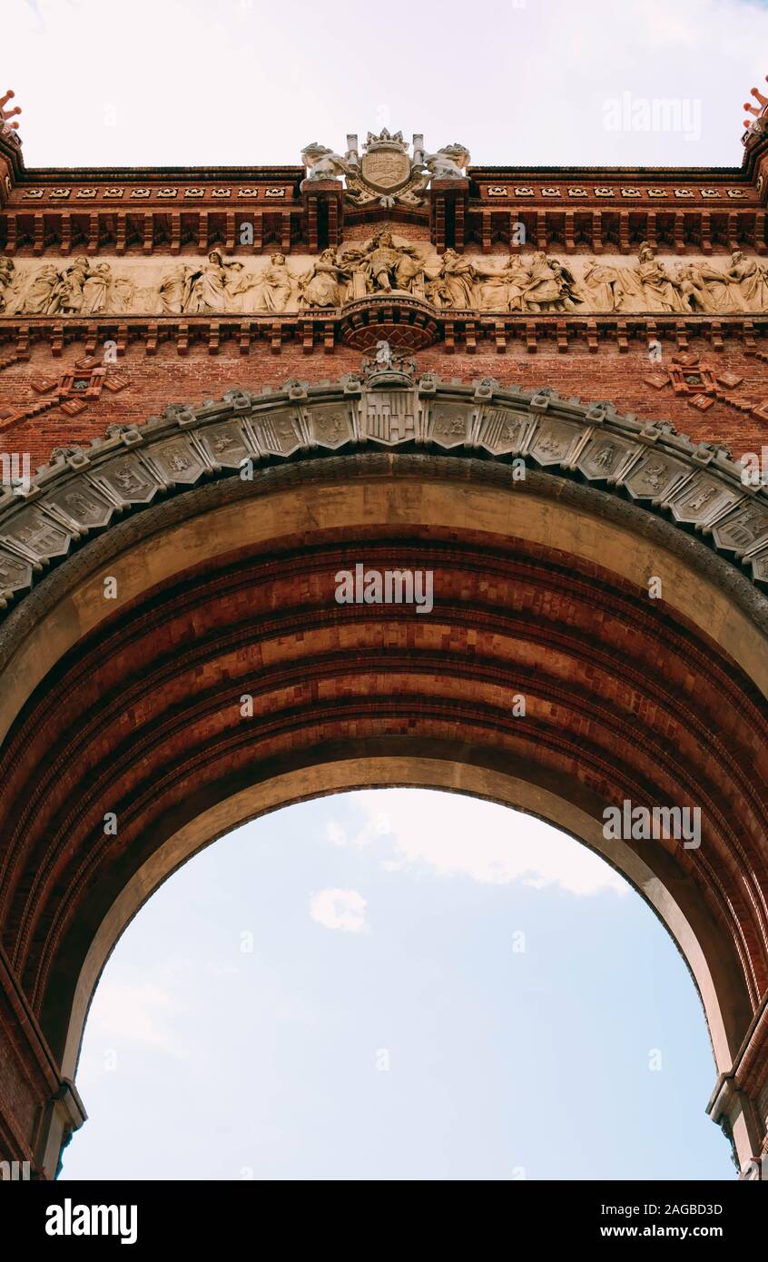 Vertical low angle shot of a concrete arch with beautiful carvings ...