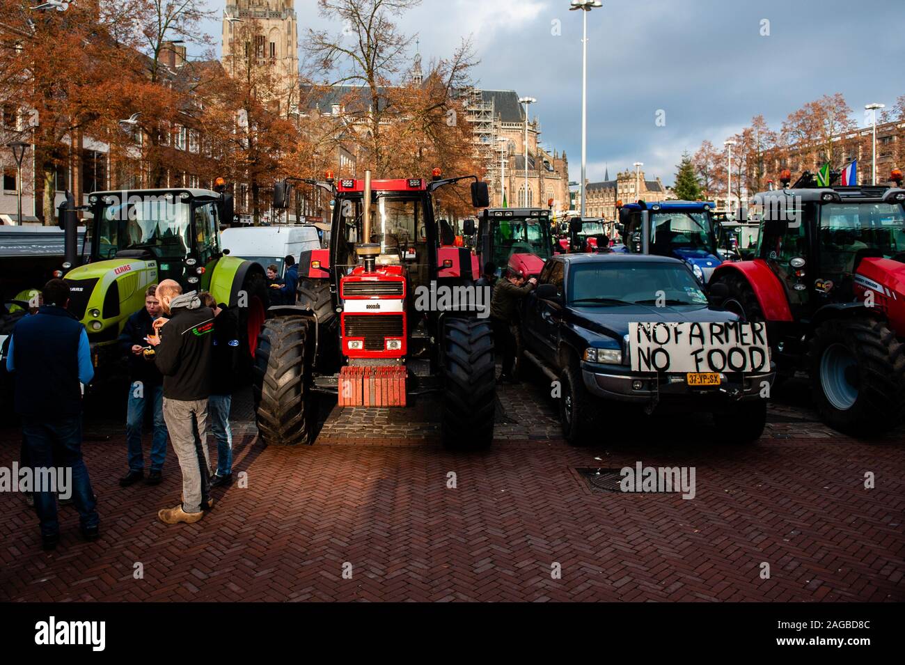 Farmers eat in front of their tractors during the demonstration ...