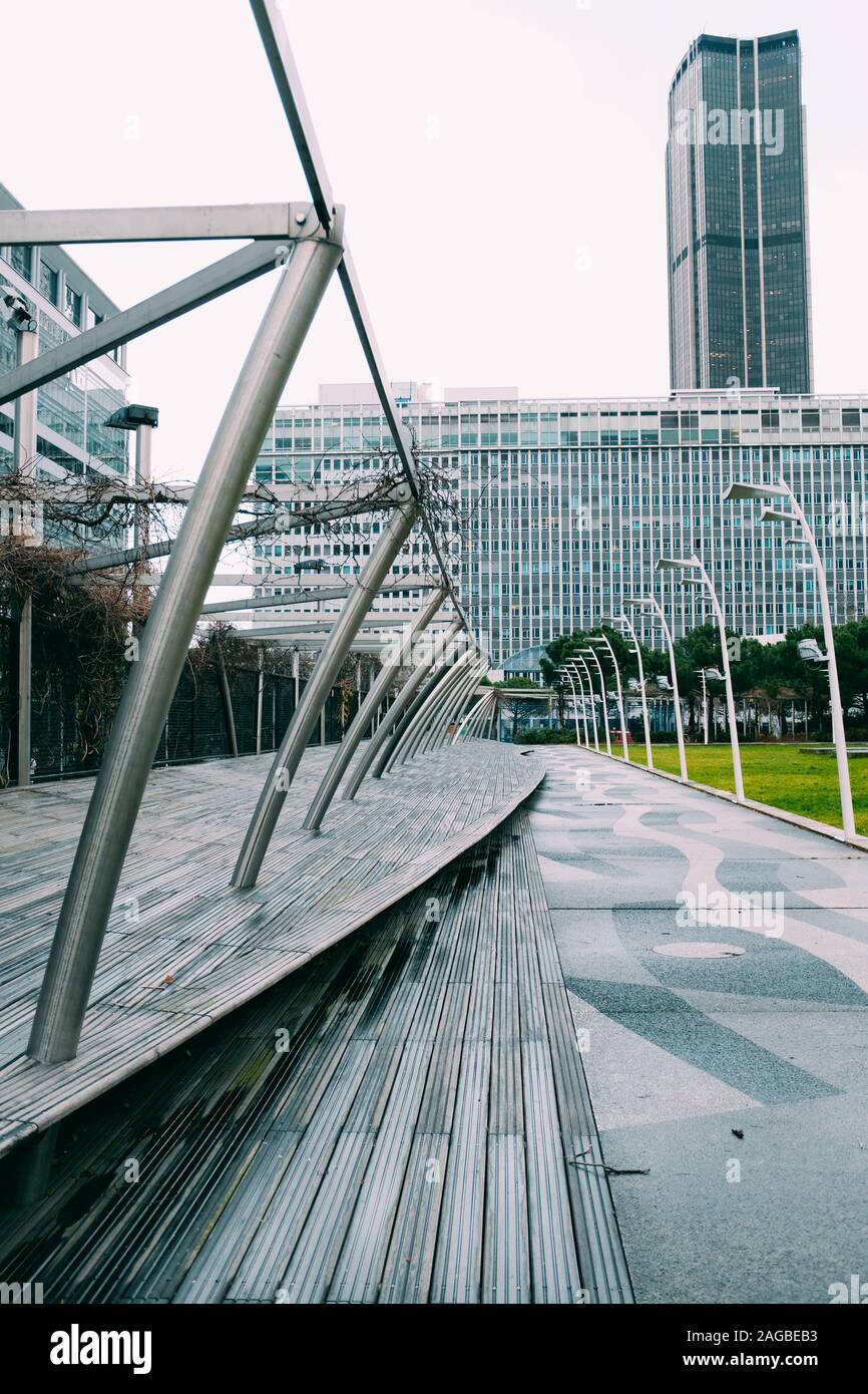 Vertical shot of a metal pathway in front of glass buildings Stock ...