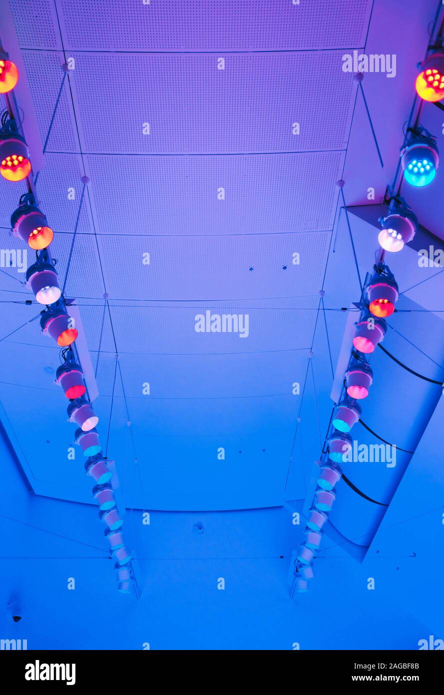 Low angle shot of a blue gradient ceiling with colorful lights hanging ...