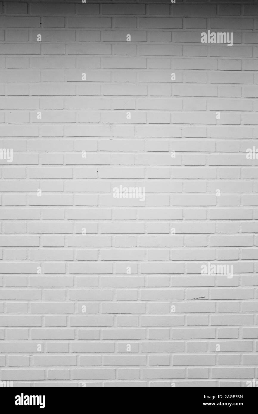 Cool background of a white painted stone wall under lights in a room ...