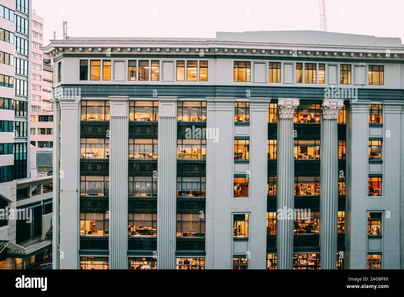 Full view of a modern white building with columns and engravings on ...