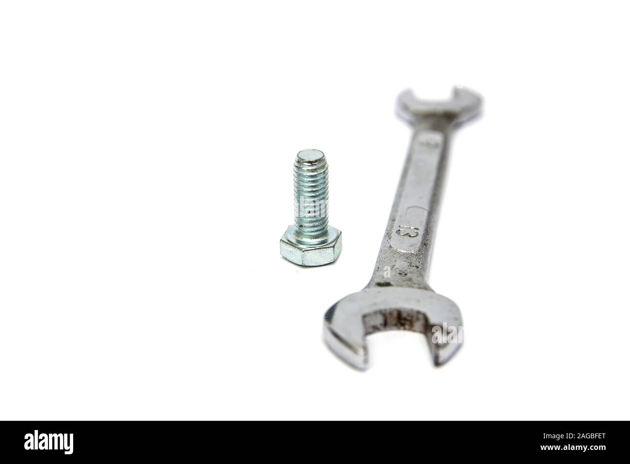 Wrench and bolt isolated on a white background Stock Photo - Alamy