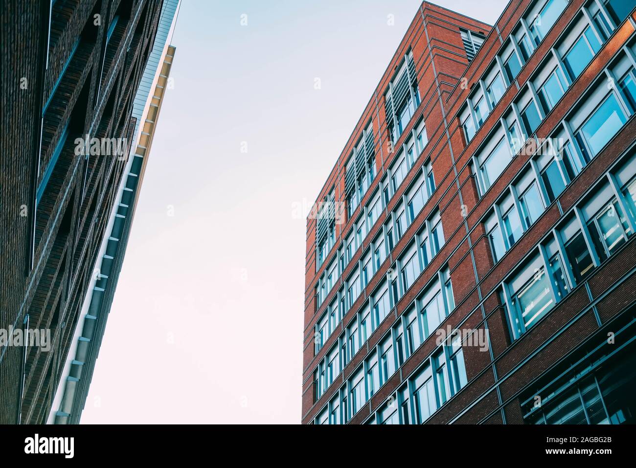Low angle shot of concrete apartment buildings with a lot of windows ...