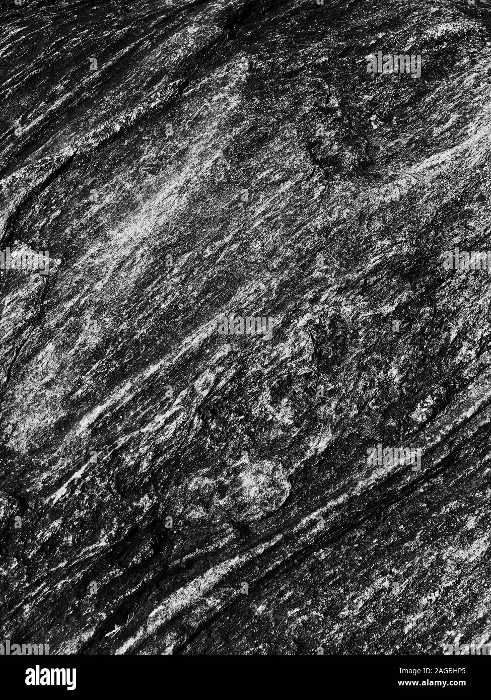 Vertical grey scale shot of a rock surface captured from a high angle ...