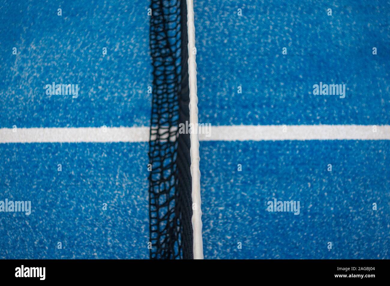 Blue paddle tennis net and court field background Stock Photo - Alamy