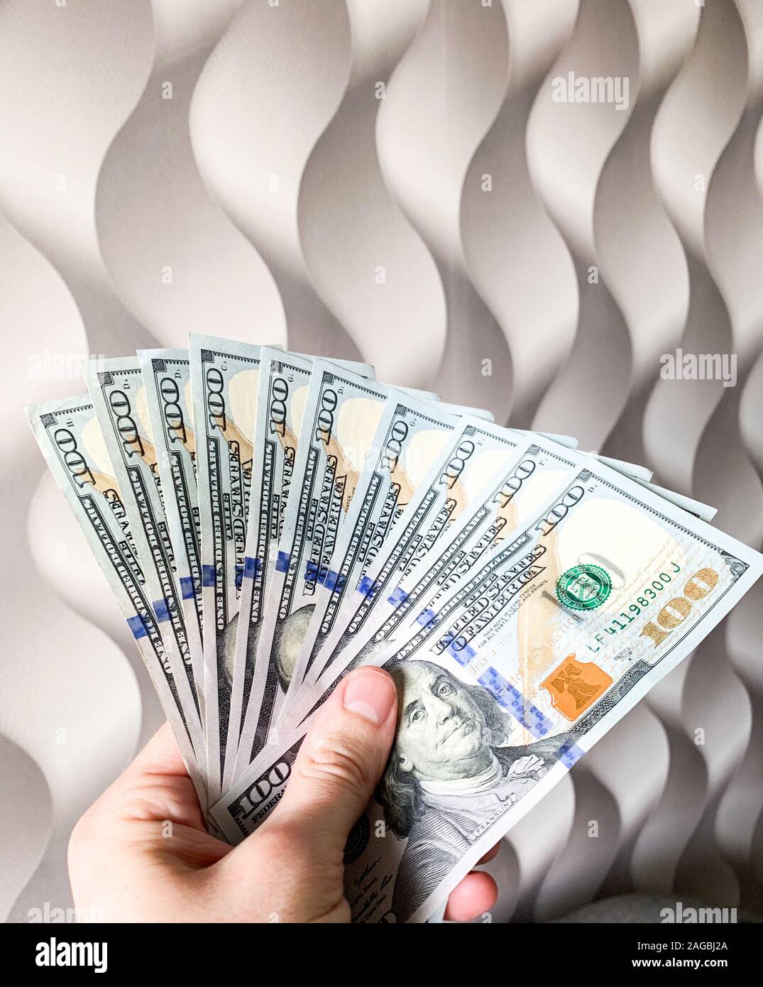 Hand holding banknote bundle of US dollar in hand Stock Photo - Alamy