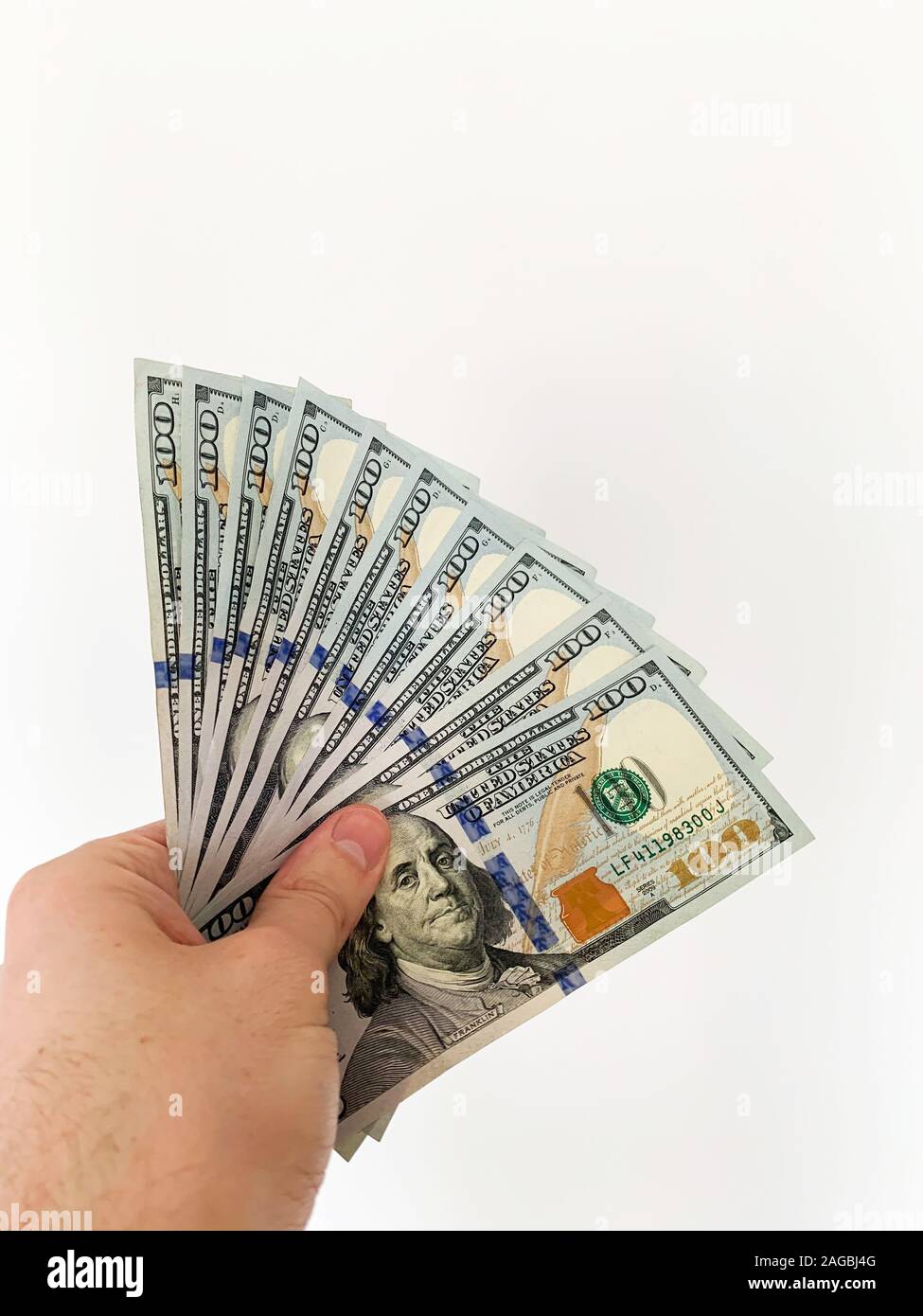 Hand holding banknote bundle of US dollar in hand Stock Photo - Alamy