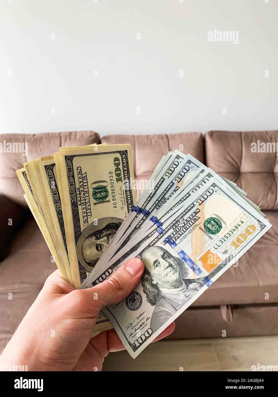 Hand holding banknote bundle of US dollar in hand Stock Photo - Alamy