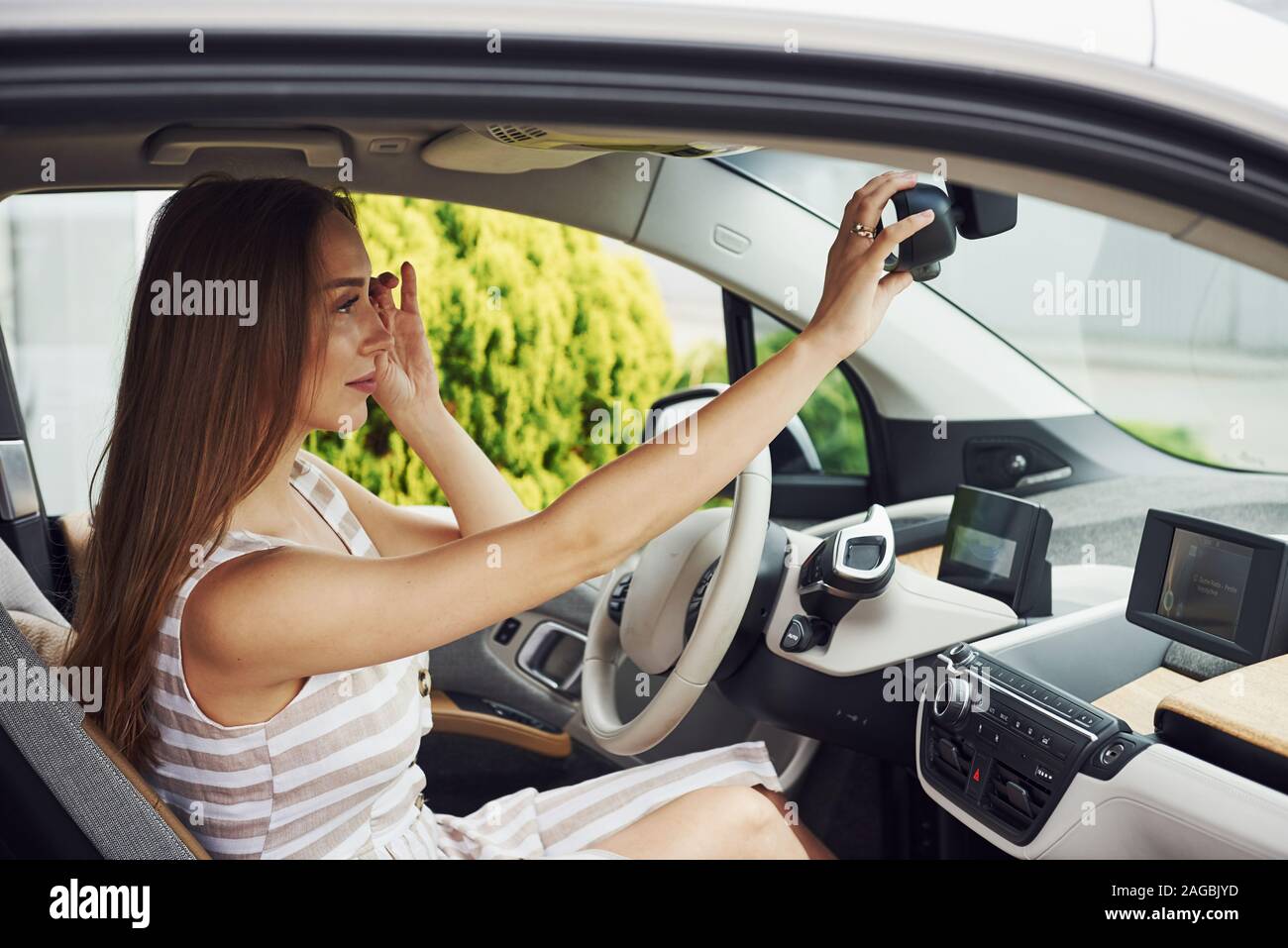 Side view. Female driver inside of modern automobile. Testing brand new ...