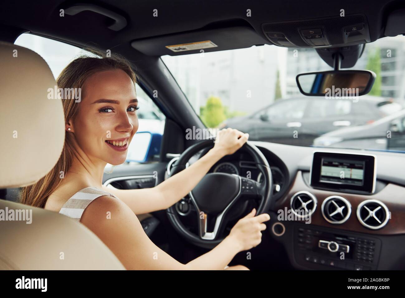 Female driver inside of modern automobile. Testing brand new car Stock ...