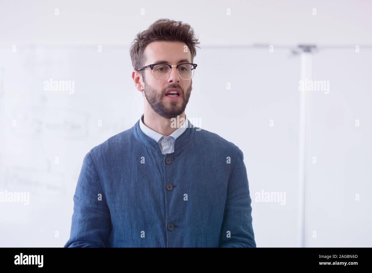 Portrait of male teacher at work. Male professor explain to students ...