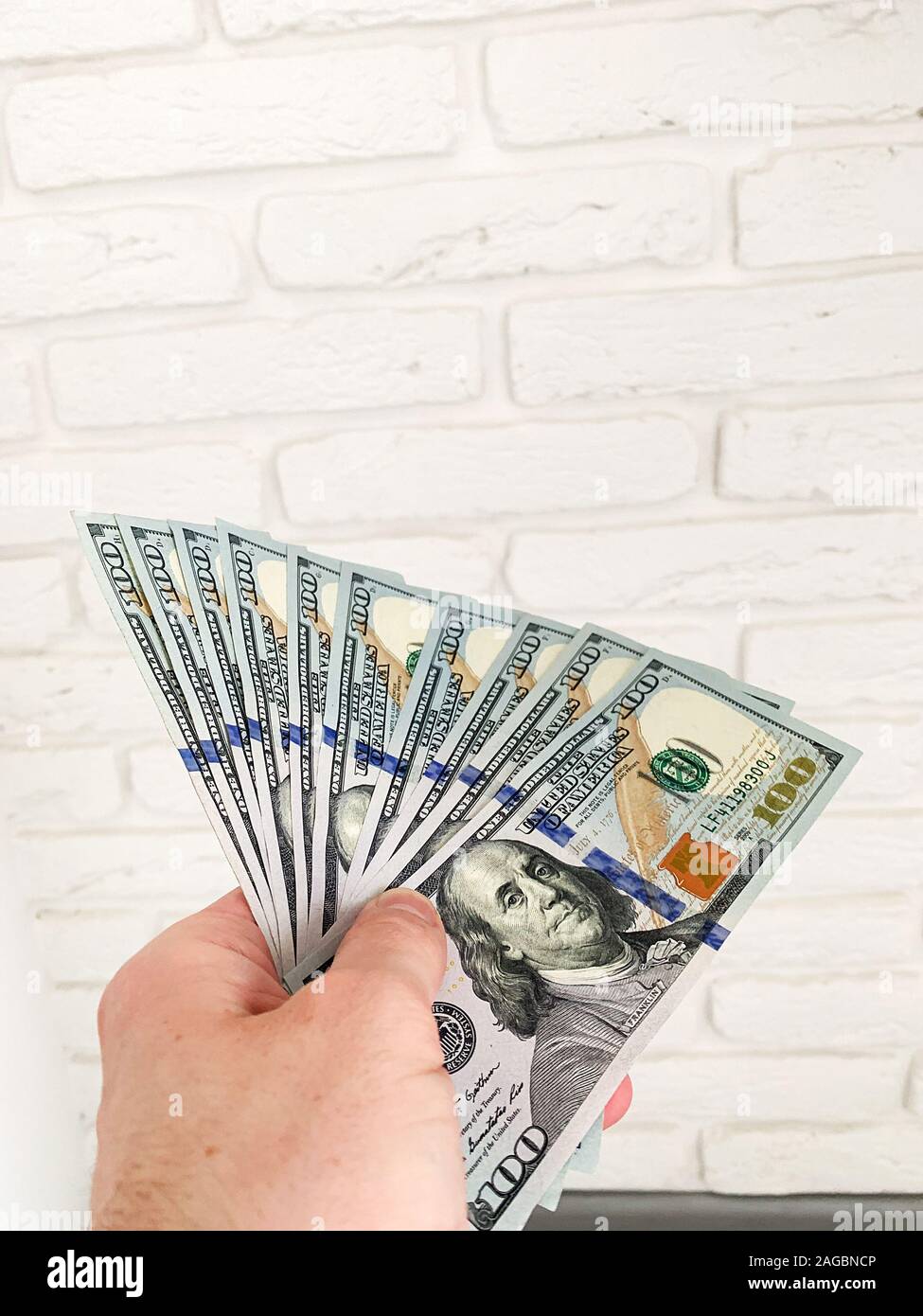 Finance money. Closeup of hand holding dollars Stock Photo - Alamy