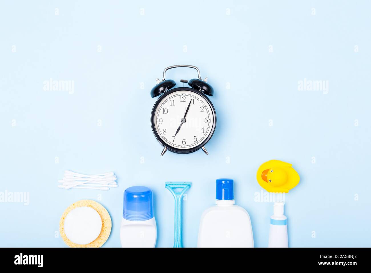 Woman bath face body care morning routine items around alarm clock flat ...