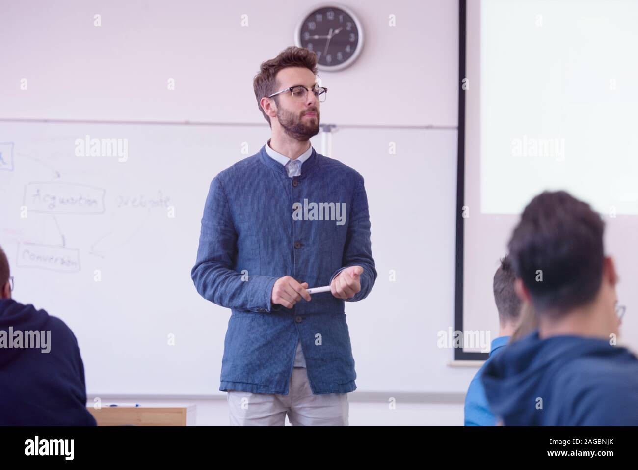 Group of students study with professor in modern school classroom. Male ...