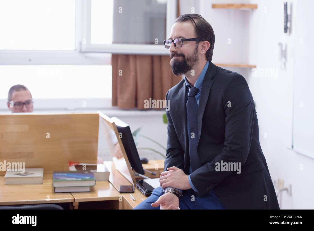 Group of students study with professor in modern school classroom. Male ...