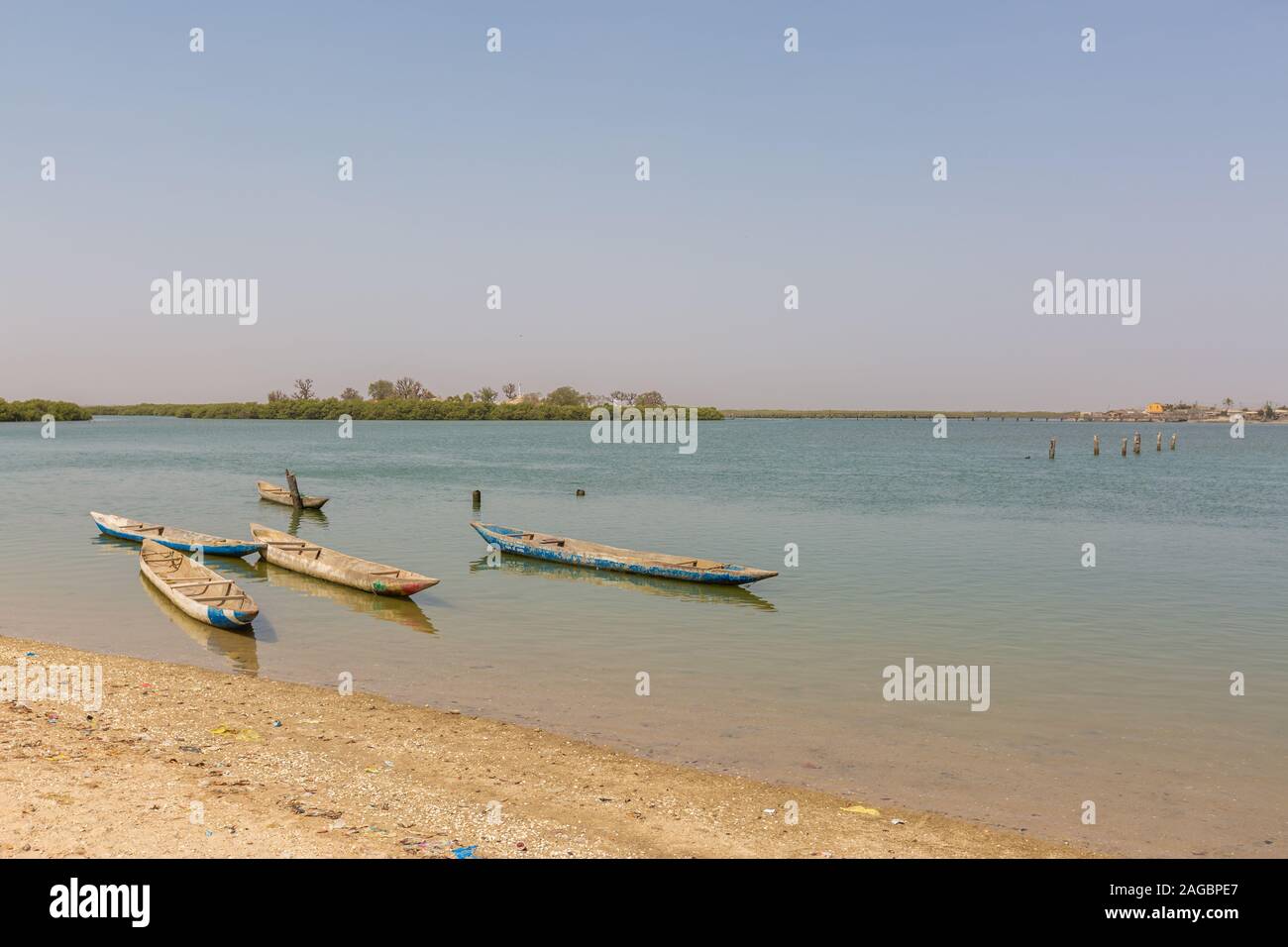 Landscape of wooden boats on the sea with greenery on the background ...
